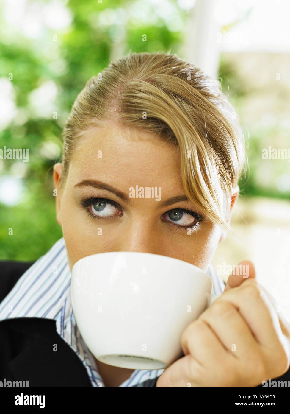 Businesswoman sipping her drink Stock Photo - Alamy