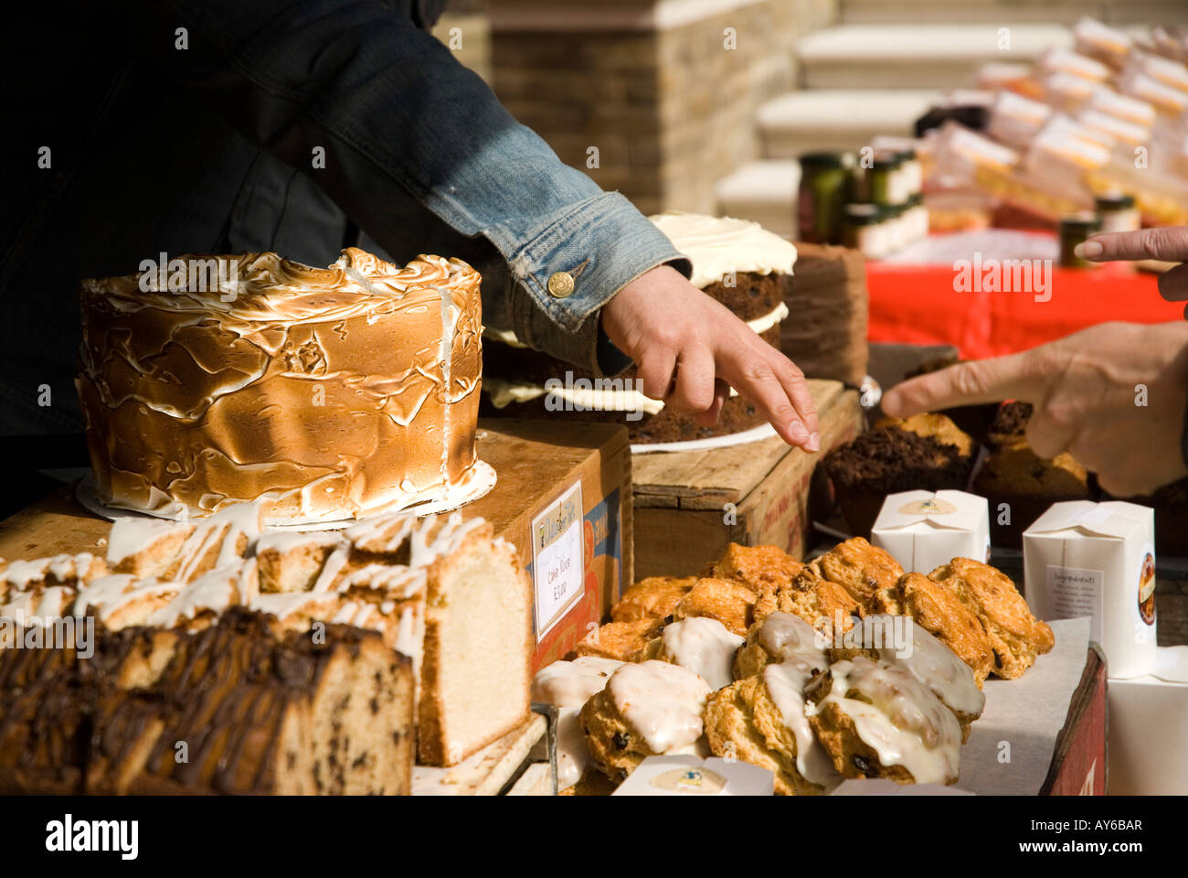 Selecting a cake on a market stall Stock Photo - Alamy
