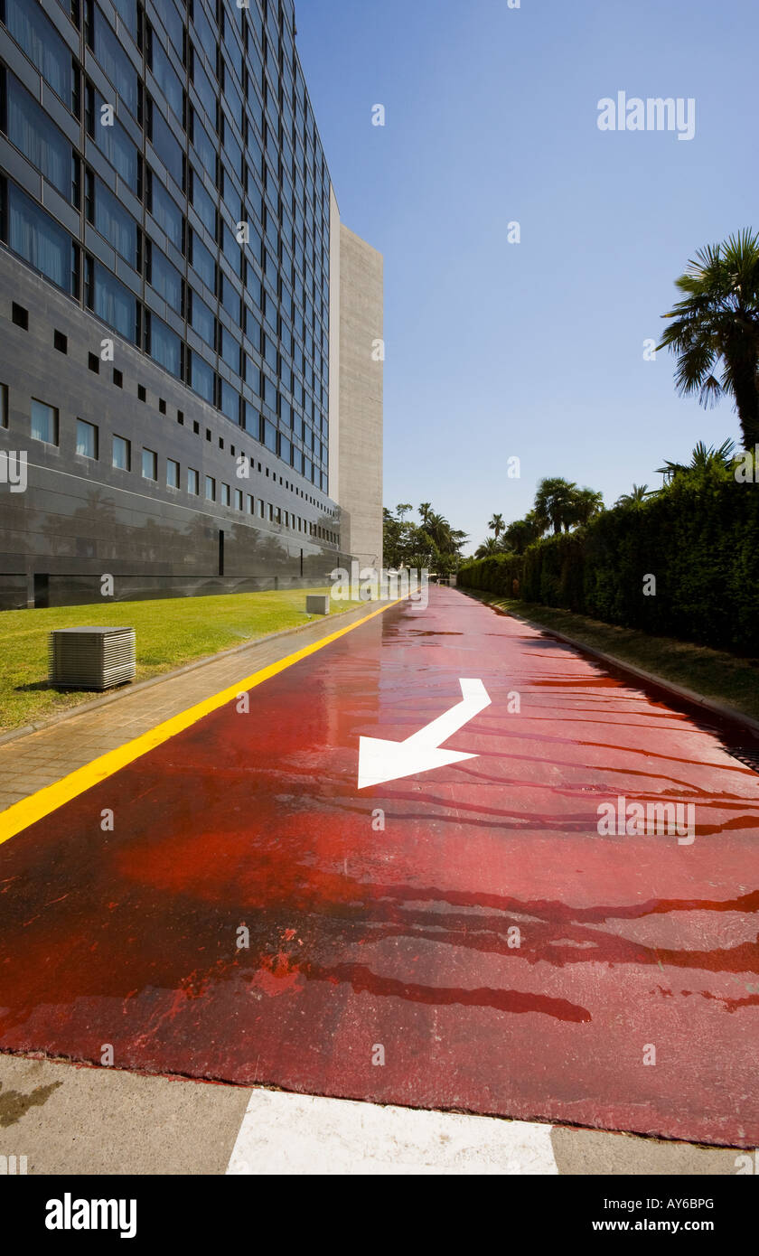 Red painted street along modern building in Barcelona Spain with white ...