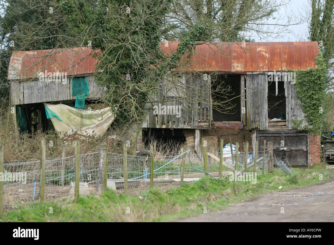 Tumble down farm barn with rusty roof and rotten wooden walls Stock ...