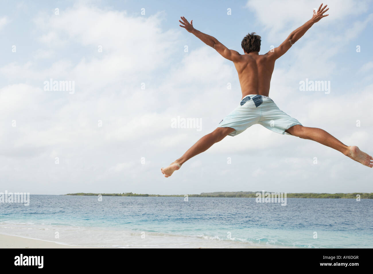 South American man jumping on beach Stock Photo - Alamy