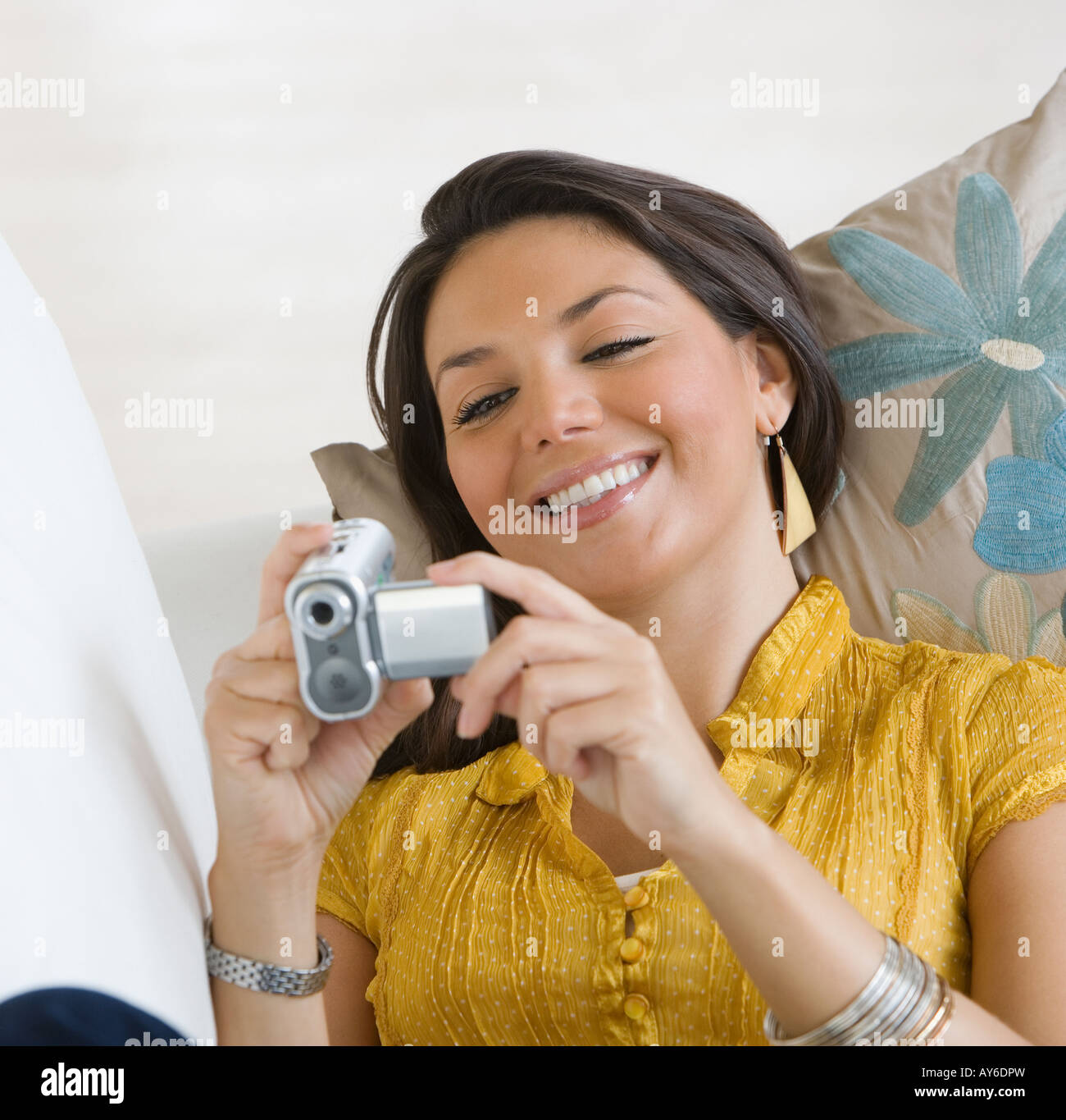 Young hispanic woman watching video hi-res stock photography and images ...
