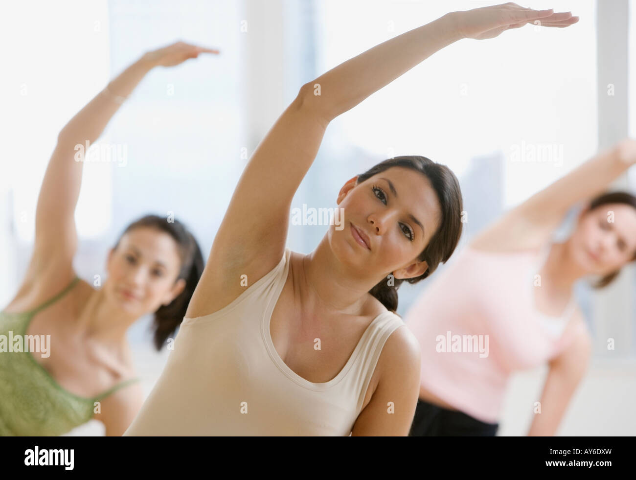 Three young women in yoga class Stock Photo - Alamy