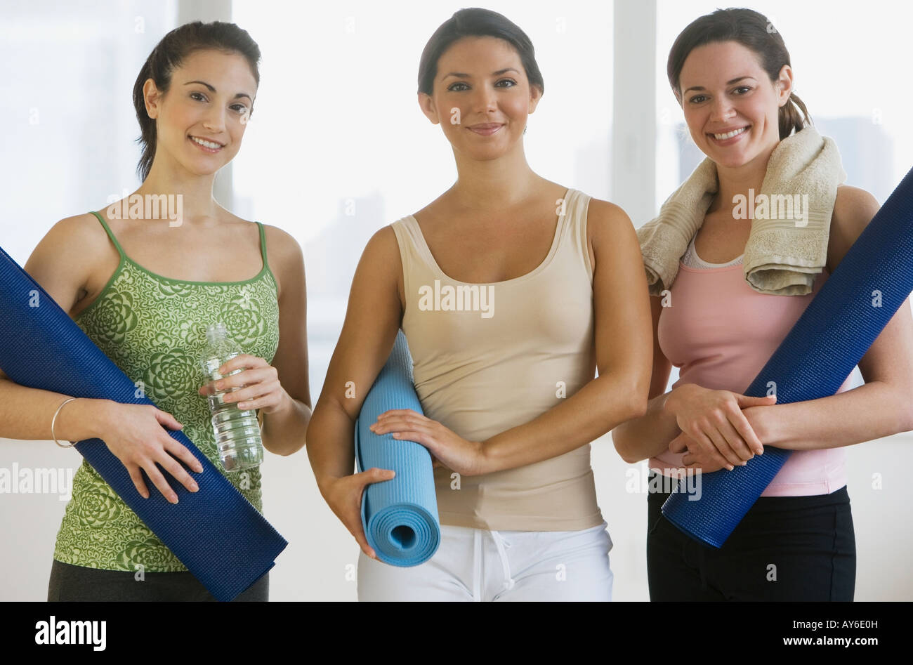 Three young women in yoga class Stock Photo - Alamy