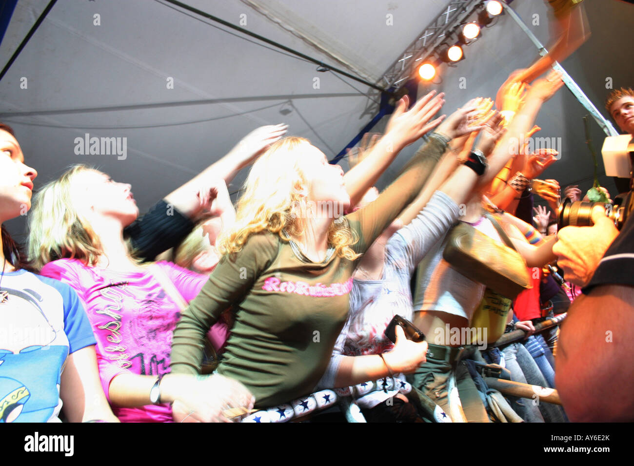 enthusiastic teenagers at rock concert reaching out to the band Stock ...