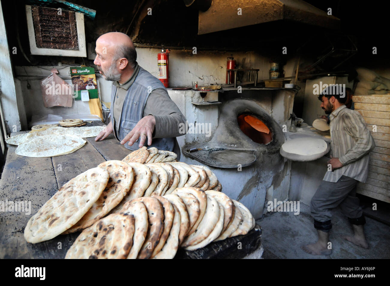 A baker making traditional Arab flat bread in Damascus, Syria Stock ...