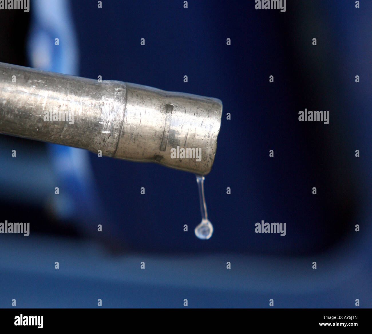 Petrol drips from the end of a pump nozzle at an Esso petrol service ...