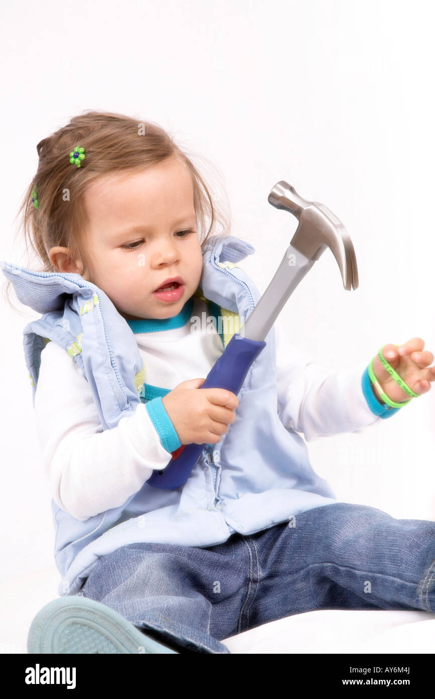 Baby girl with a hammer Stock Photo - Alamy
