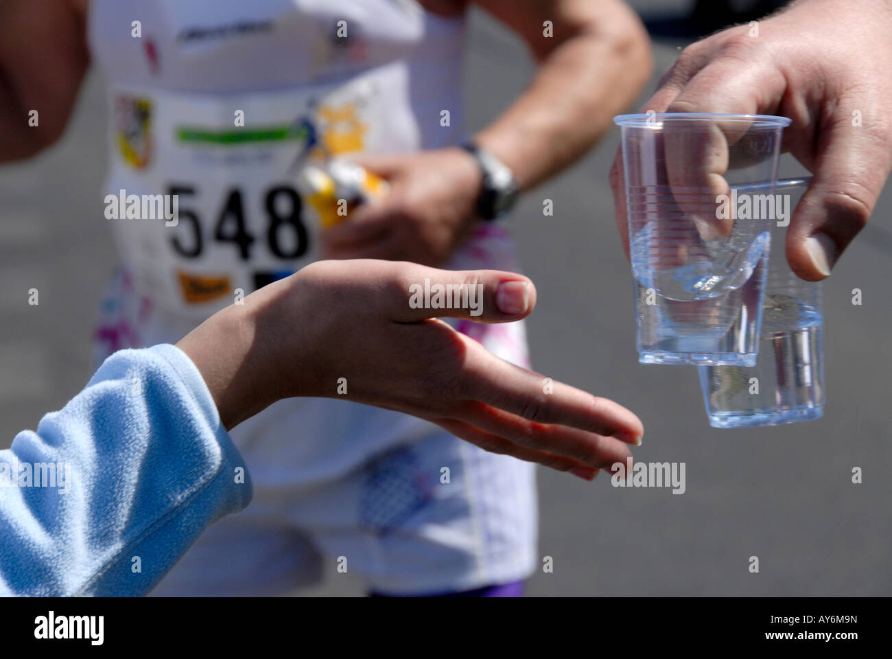 People Passing Out Cups of Water During A Marathon Stock Photo - Alamy
