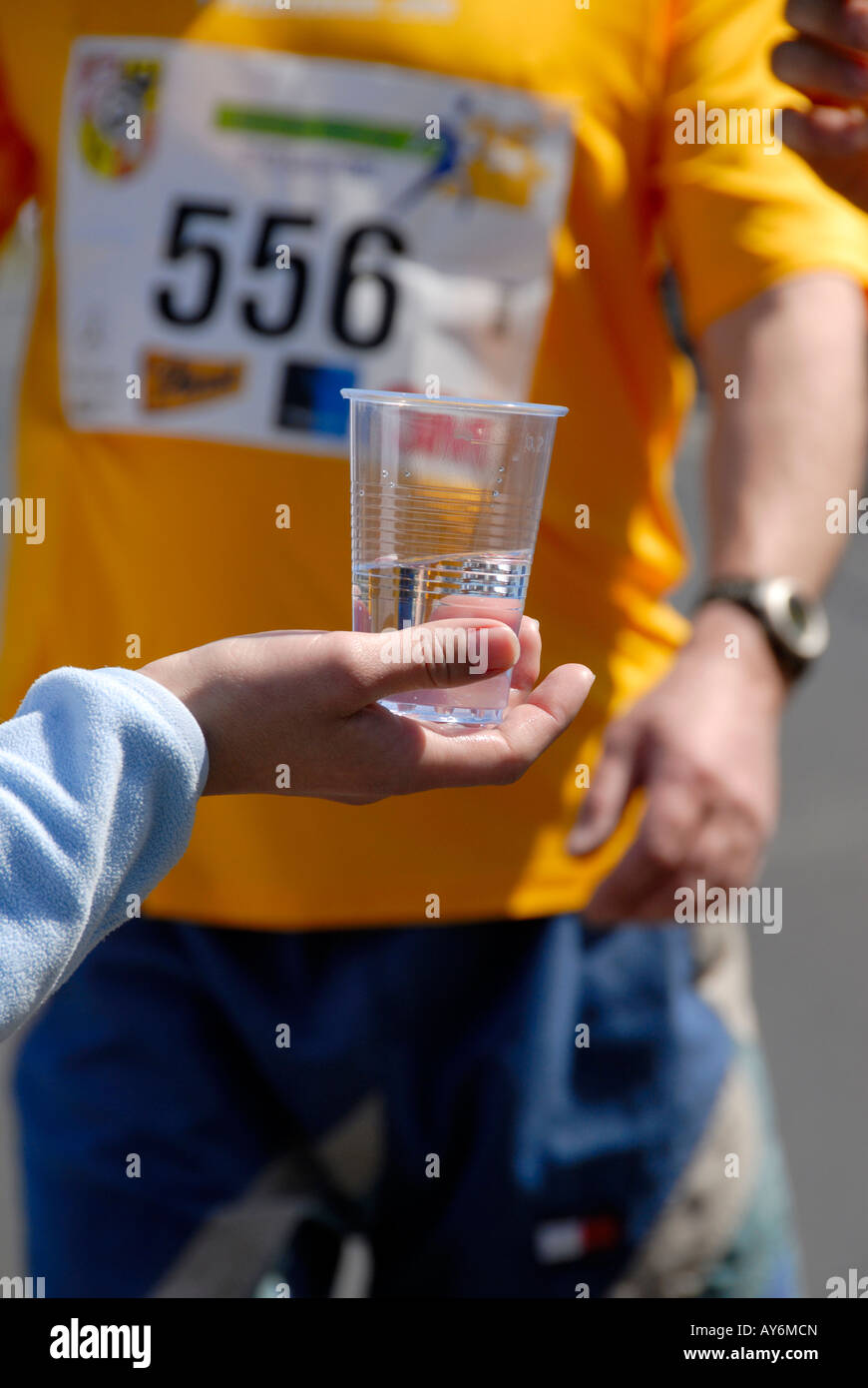 People Passing Out Cups of Water During A Marathon Stock Photo - Alamy
