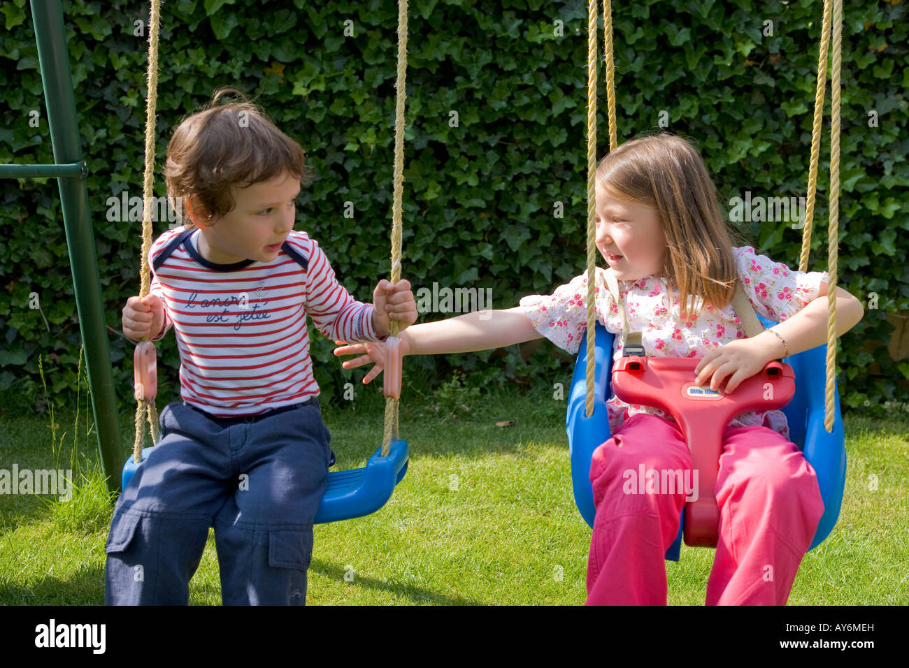 Little children on swings Stock Photo - Alamy