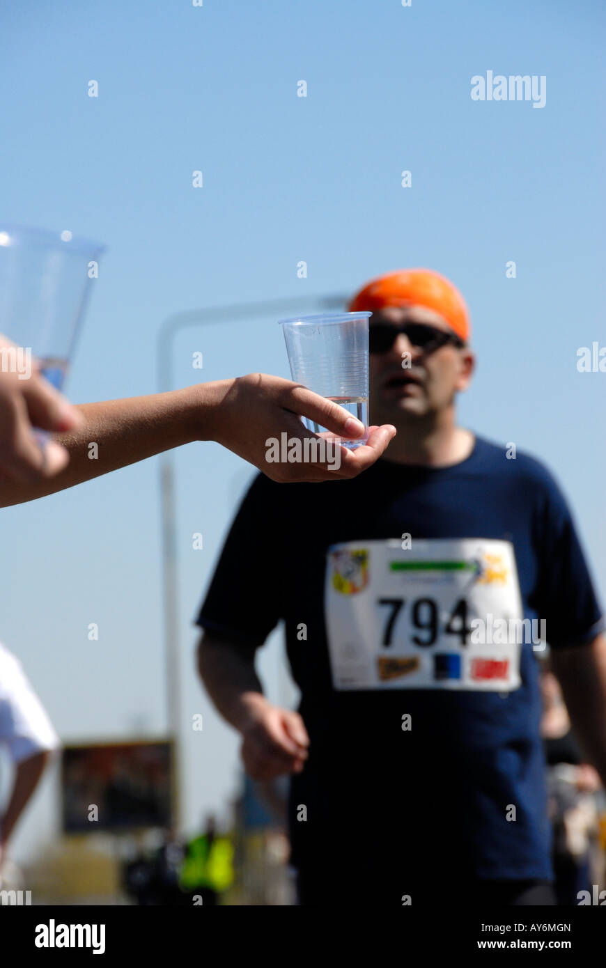 People Passing Out Cups of Water During A Marathon Stock Photo - Alamy