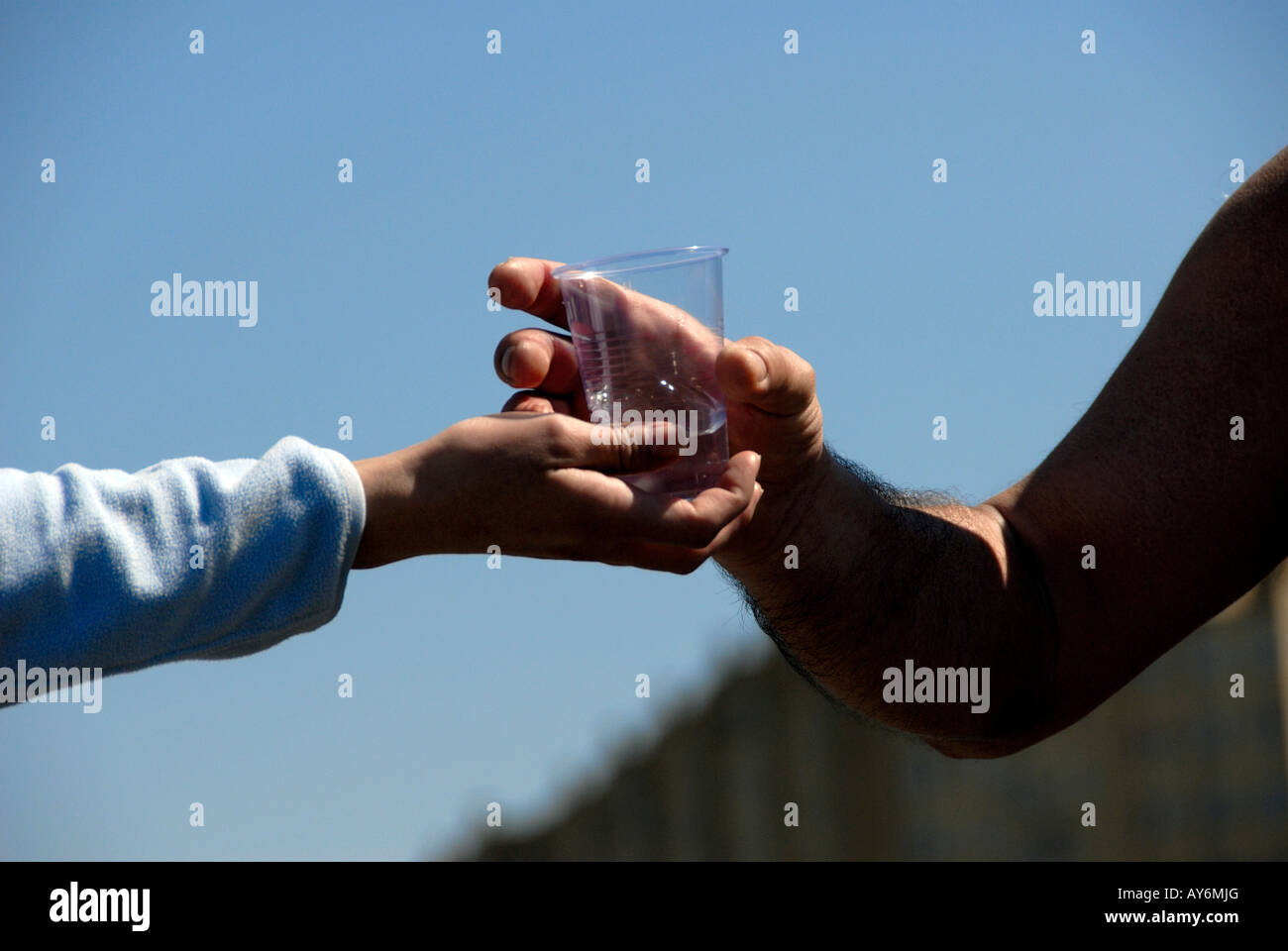 People Passing Out Cups of Water During A Marathon Stock Photo - Alamy