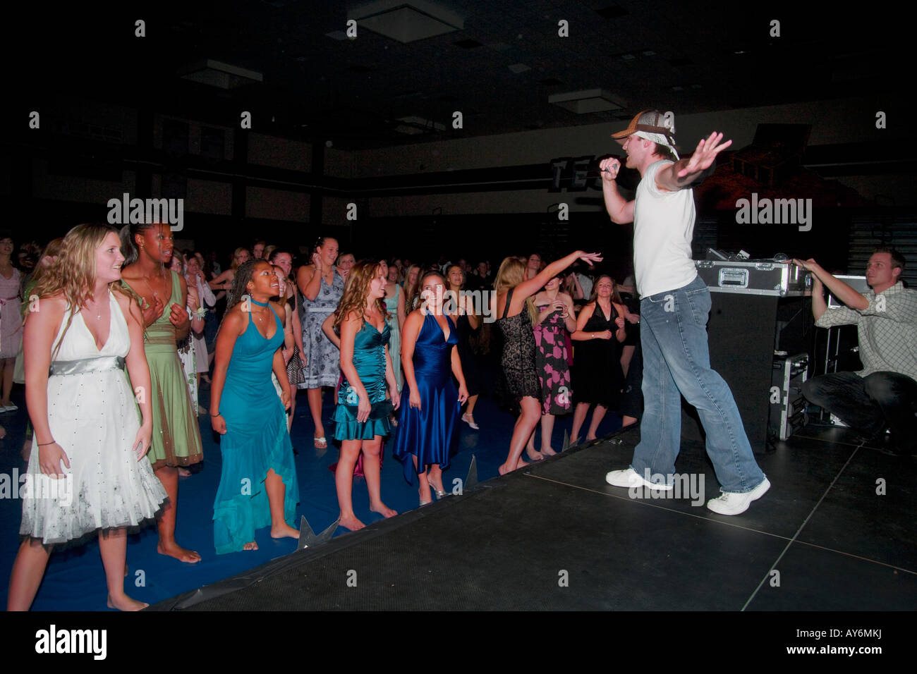 Teen girls get a dance lesson from a singer at a Dance With the Dads ...
