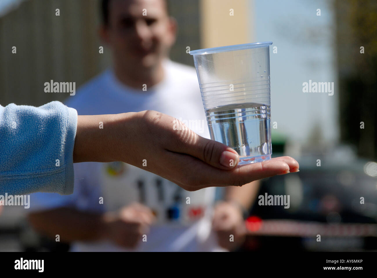 People Passing Out Cups of Water During A Marathon Stock Photo - Alamy