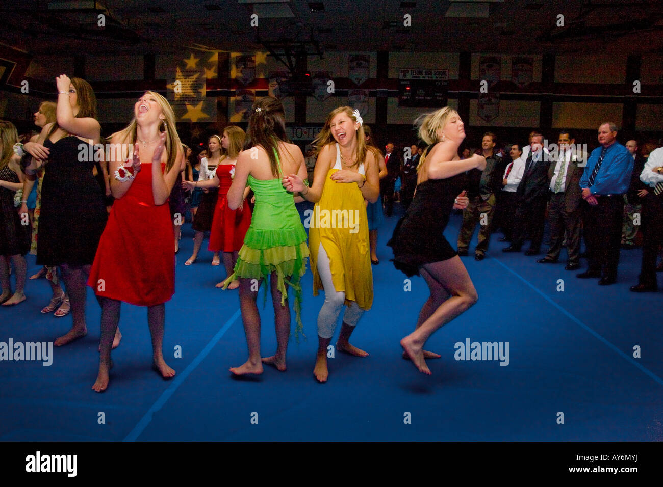 As their fathers watch teenage girls get a quick dance lesson at a ...