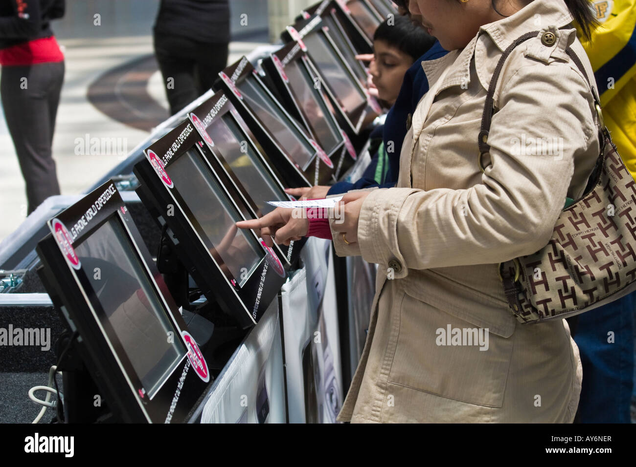 People filling out contest information on touch screen computers Stock ...