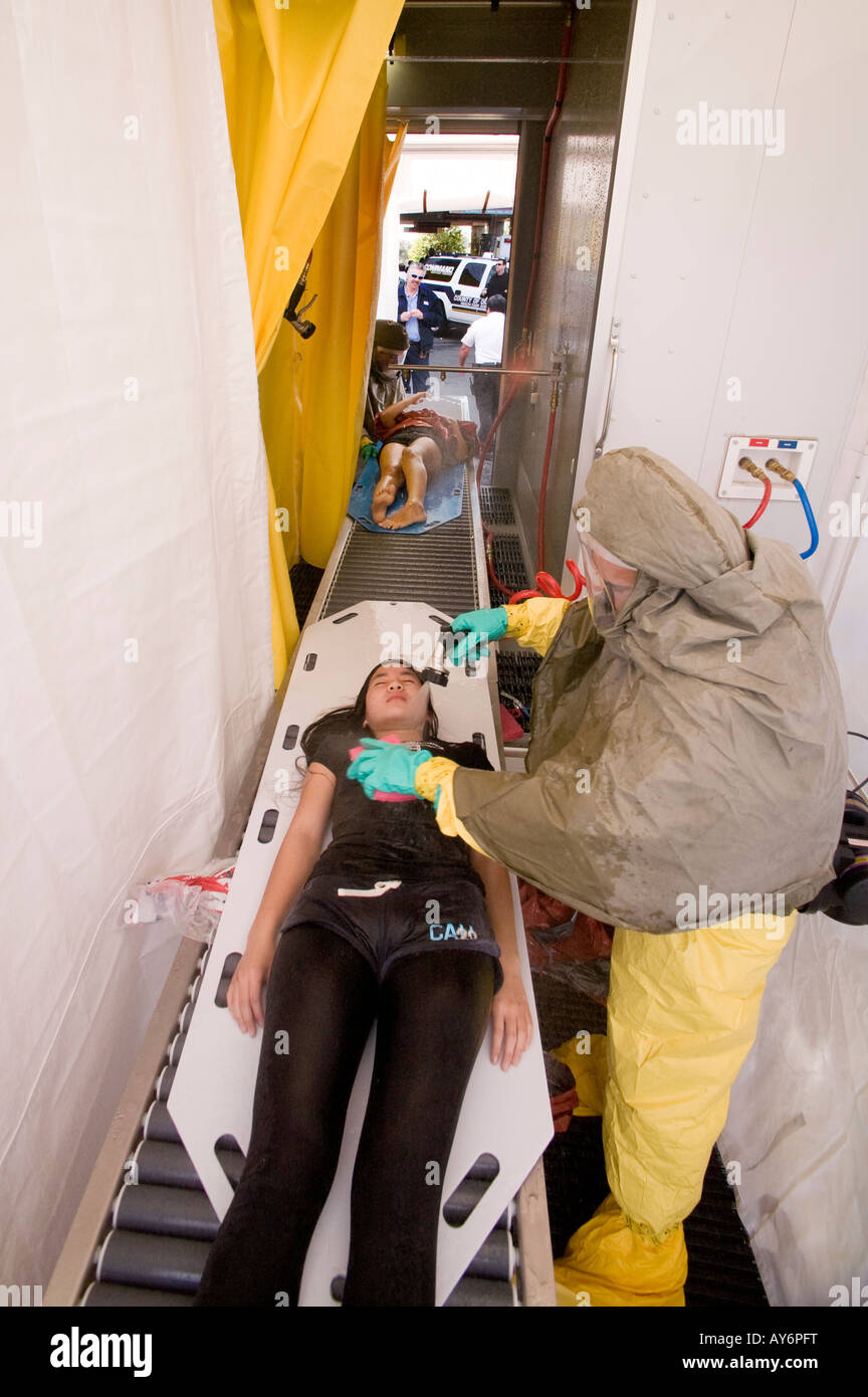 People in protective clothing care for a volunteer victim on a ...