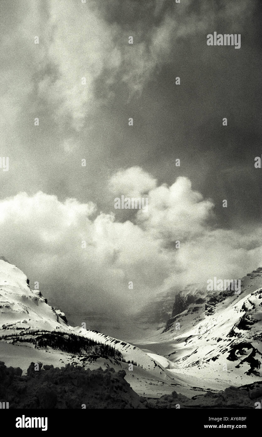 Winter blizzard conditions approaching mountain range, in the Canadian ...