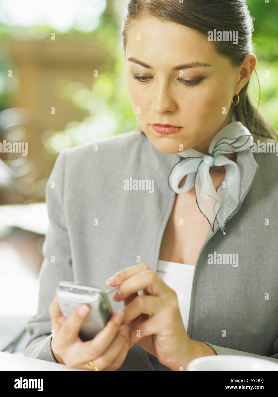 Blonde businesswoman working with her personal digital assistant Stock ...