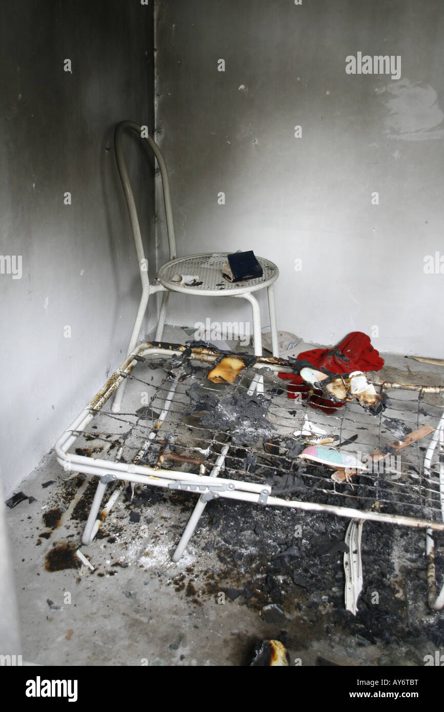 homeless burn bed and chair in a derelict building Stock Photo - Alamy