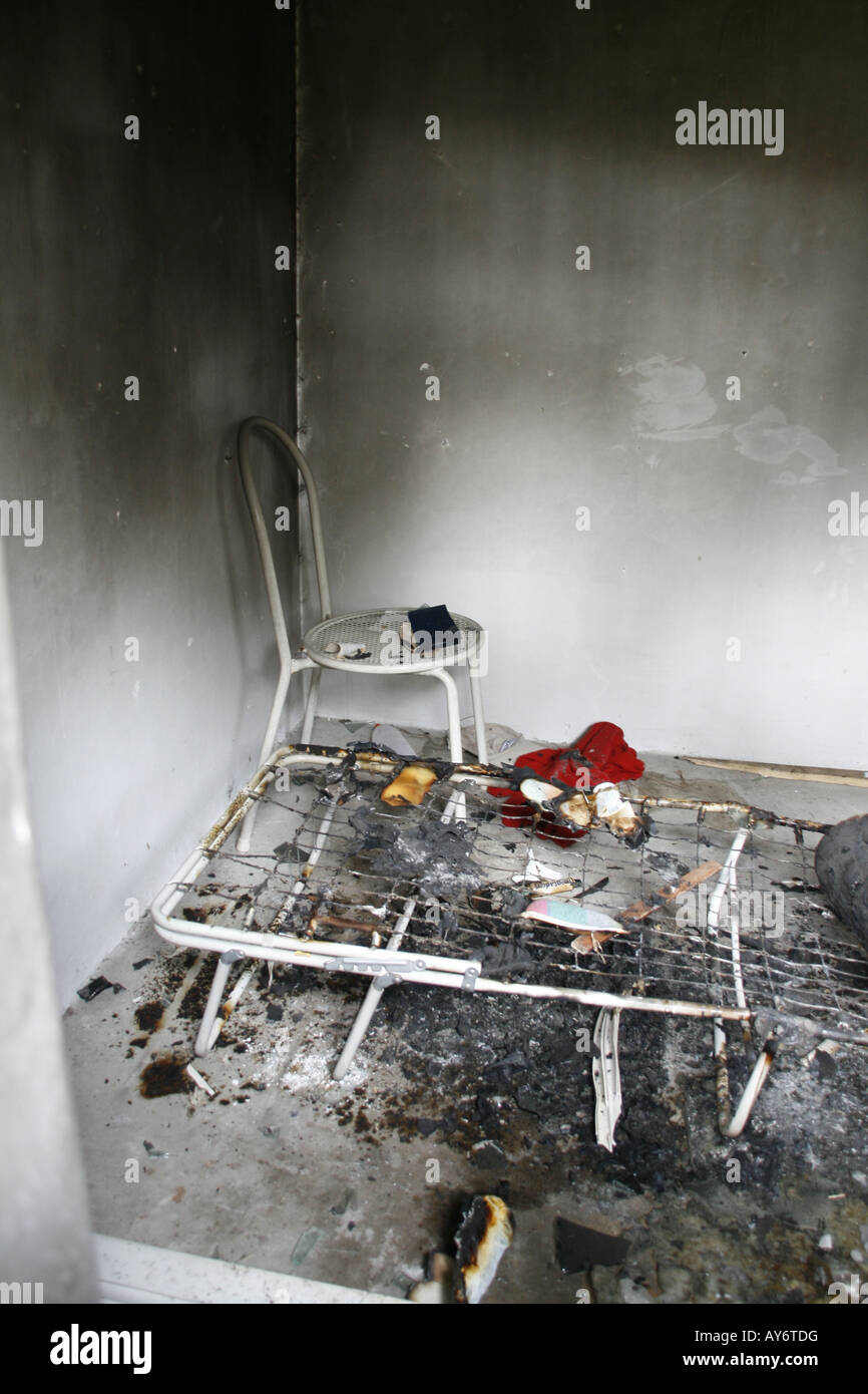 homeless burn bed and chair in a derelict building Stock Photo - Alamy