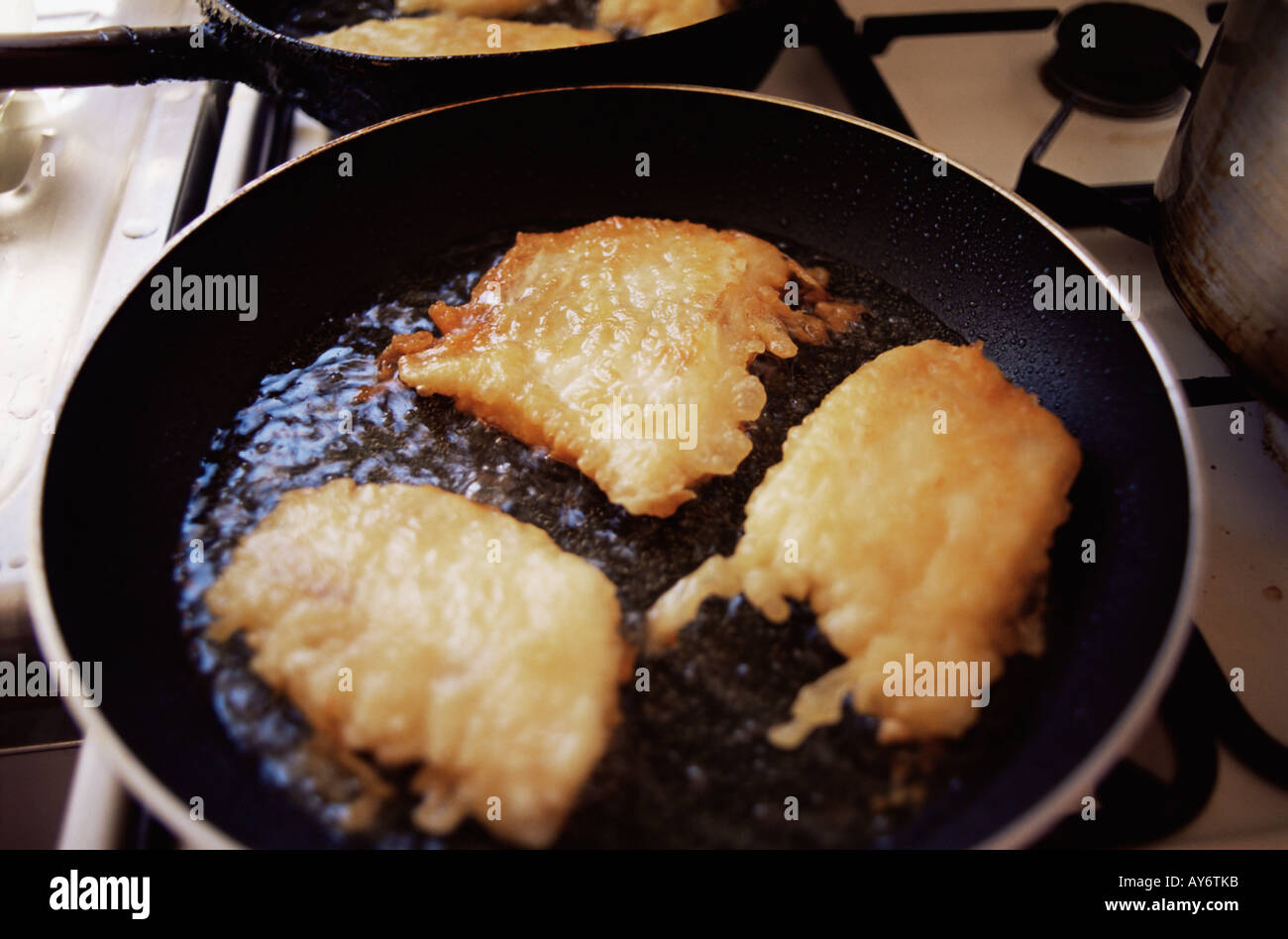 Fish frying in pan Stock Photo - Alamy