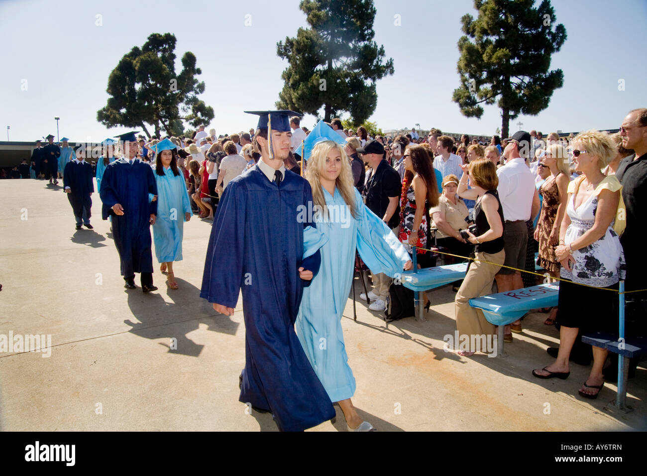 Proud high school seniors march past well wishers during graduation ...