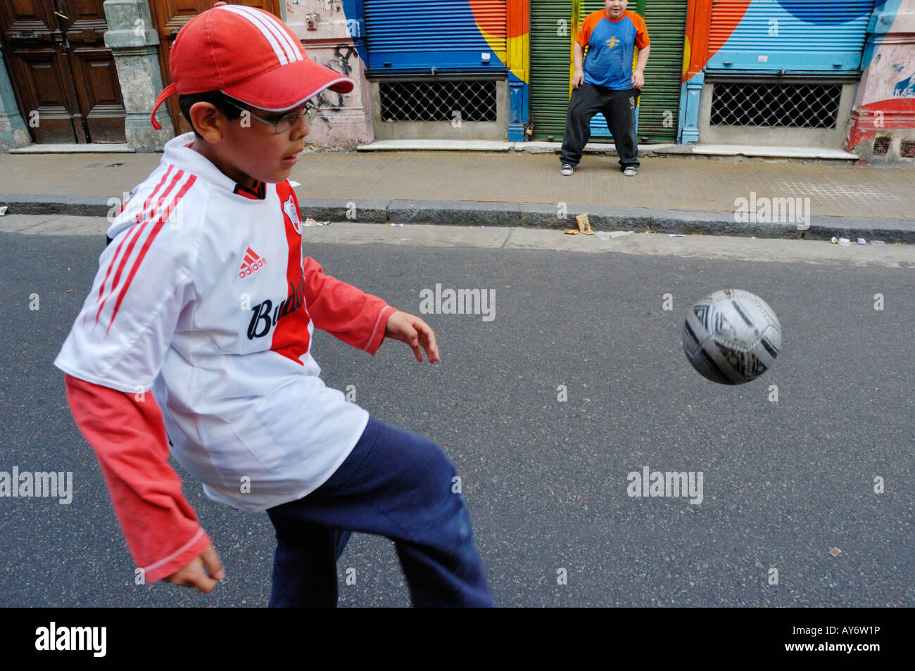 Children playing street football in San Telmo, Defensa Street, City of ...