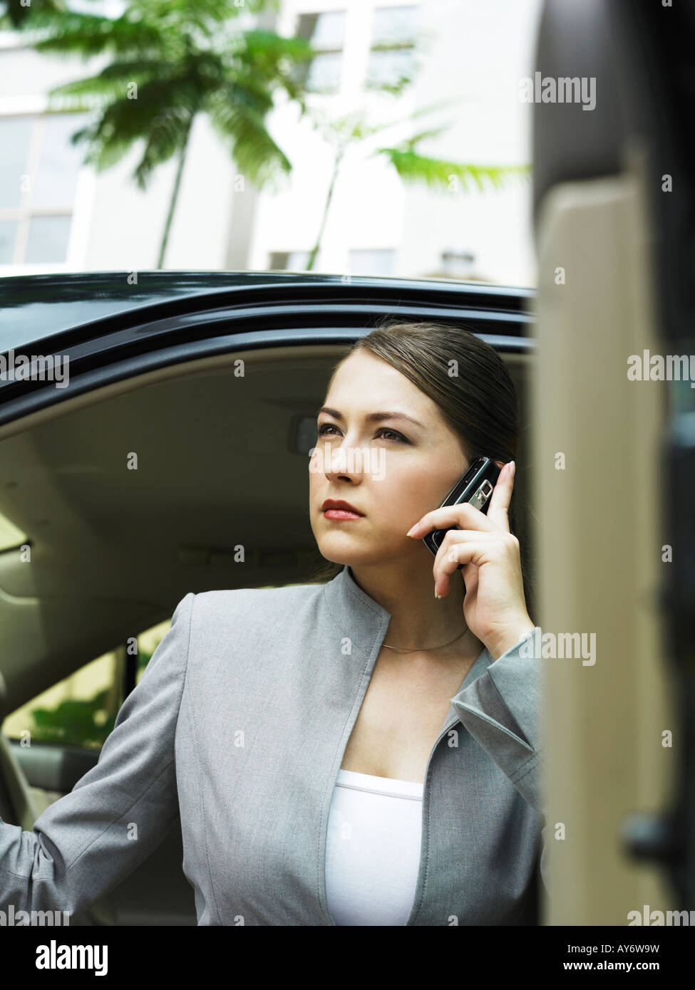 Business woman answering a phone call, about to get out of car Stock ...