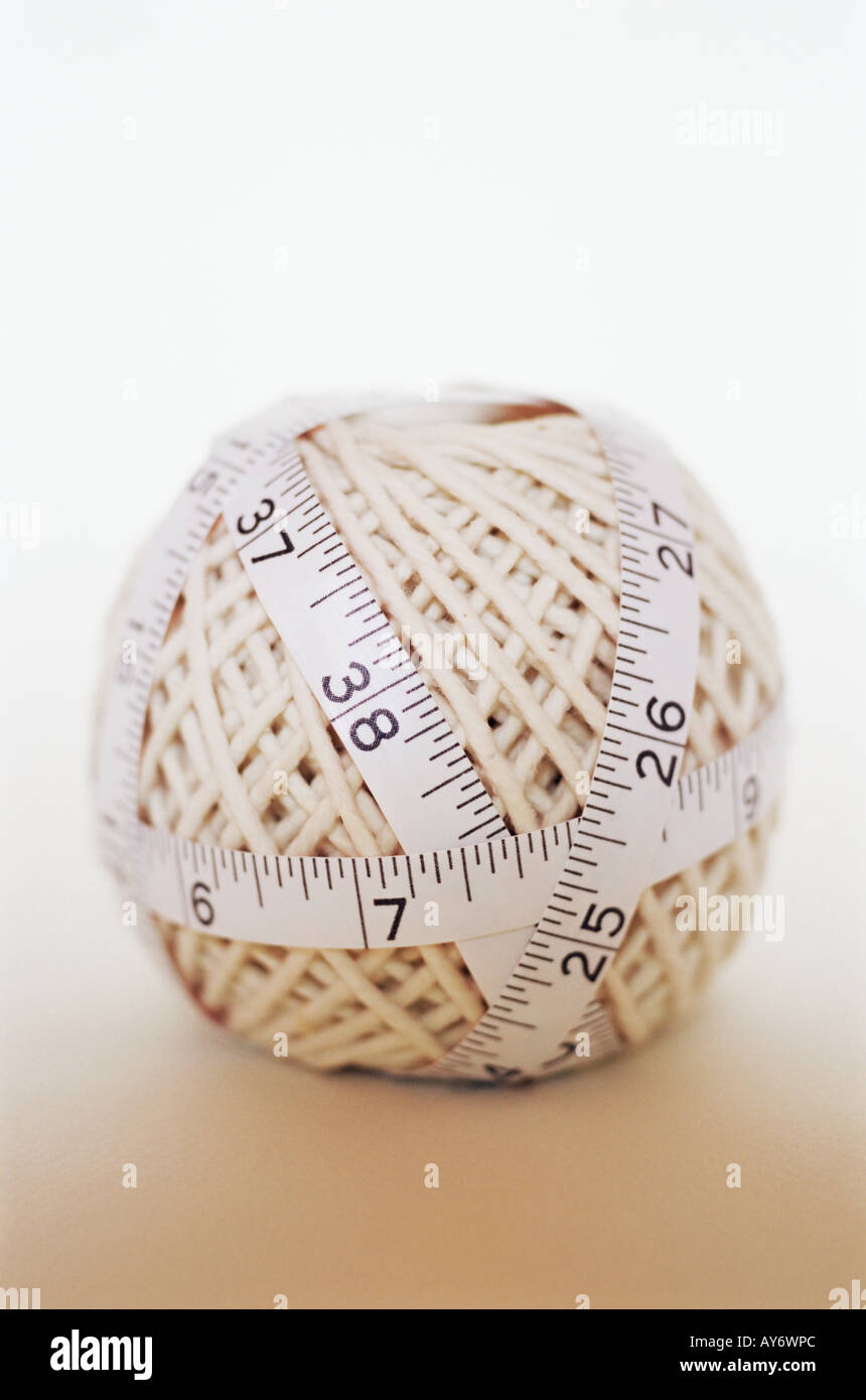 String wrapped in a tape measure how long is a piece of string Stock ...