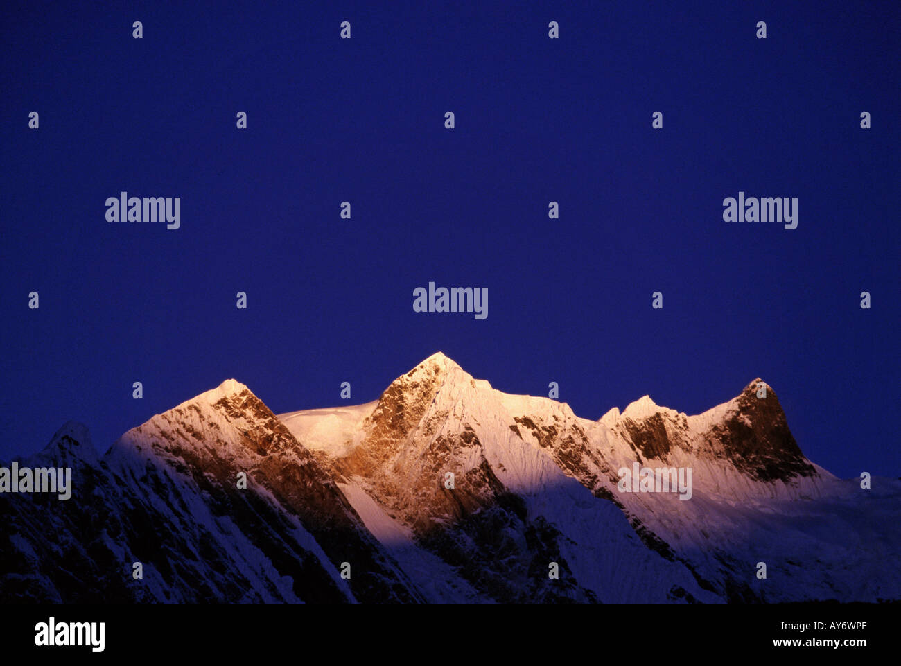 The dawn rays of the sun over Fang mountain 7647m in the Annapurna ...