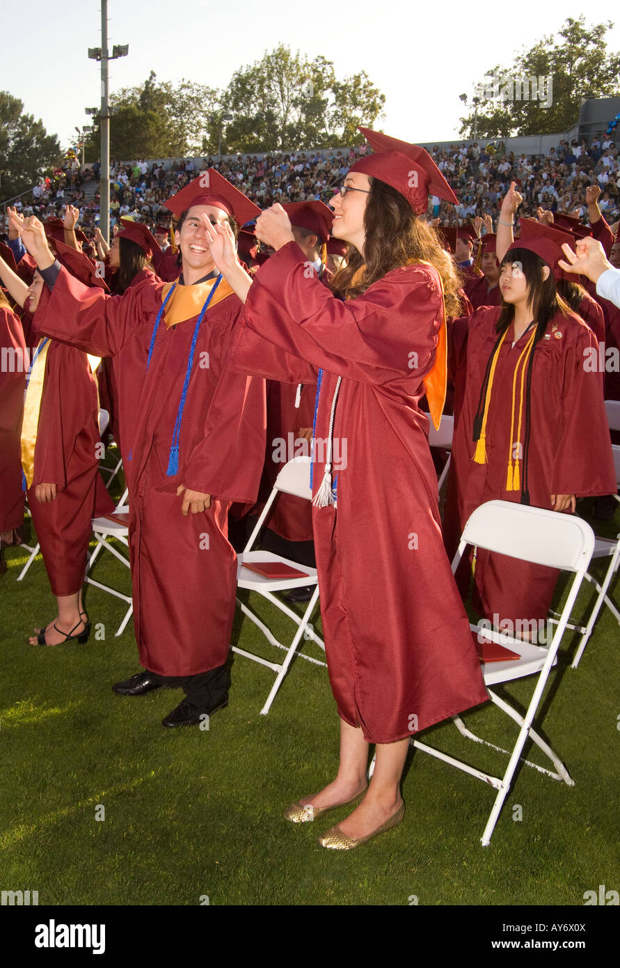 In traditional caps and gowns graduating high school seniors sing the ...