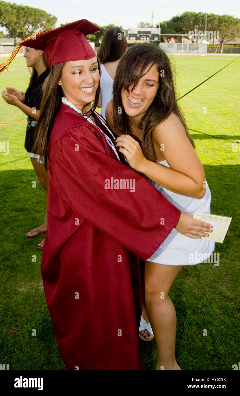 Graduating high school senior gets a hug from a classmate during ...