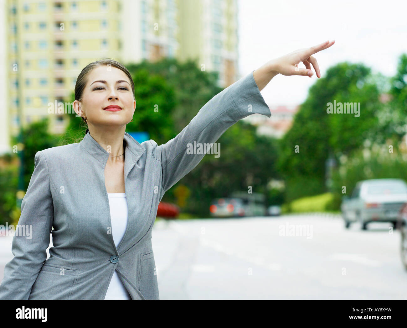 A woman hailing a cab Stock Photo - Alamy