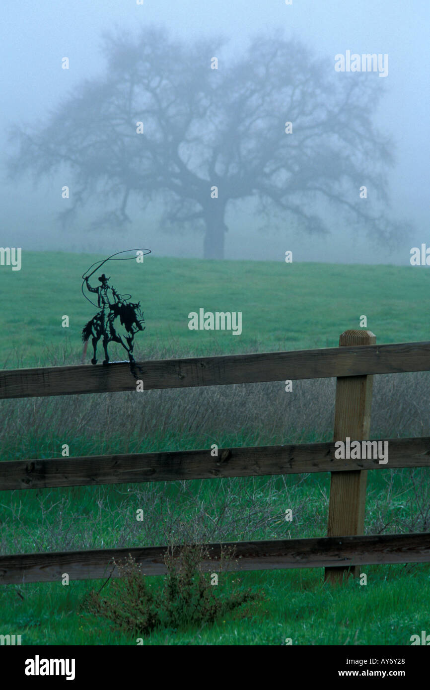 fence around western ranch with cowboy in California Stock Photo - Alamy