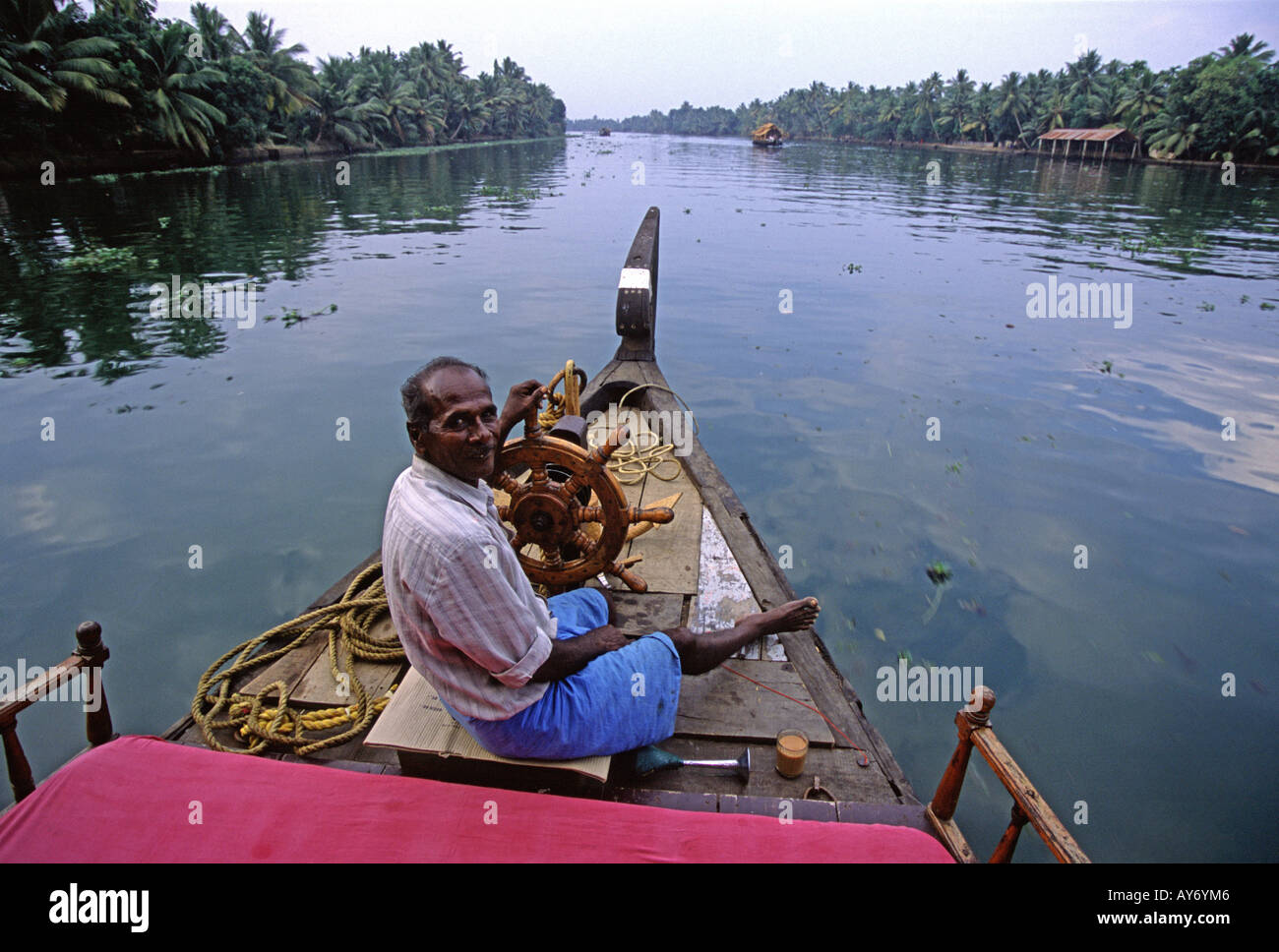 Boat driver on a houseboat on the backwaters of Kerala in India Stock ...