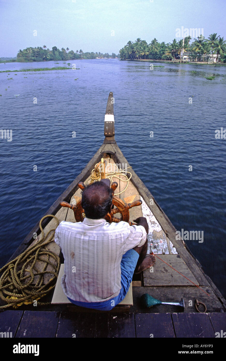 Boat driver on a houseboat on the backwaters of Kerala in India Stock ...