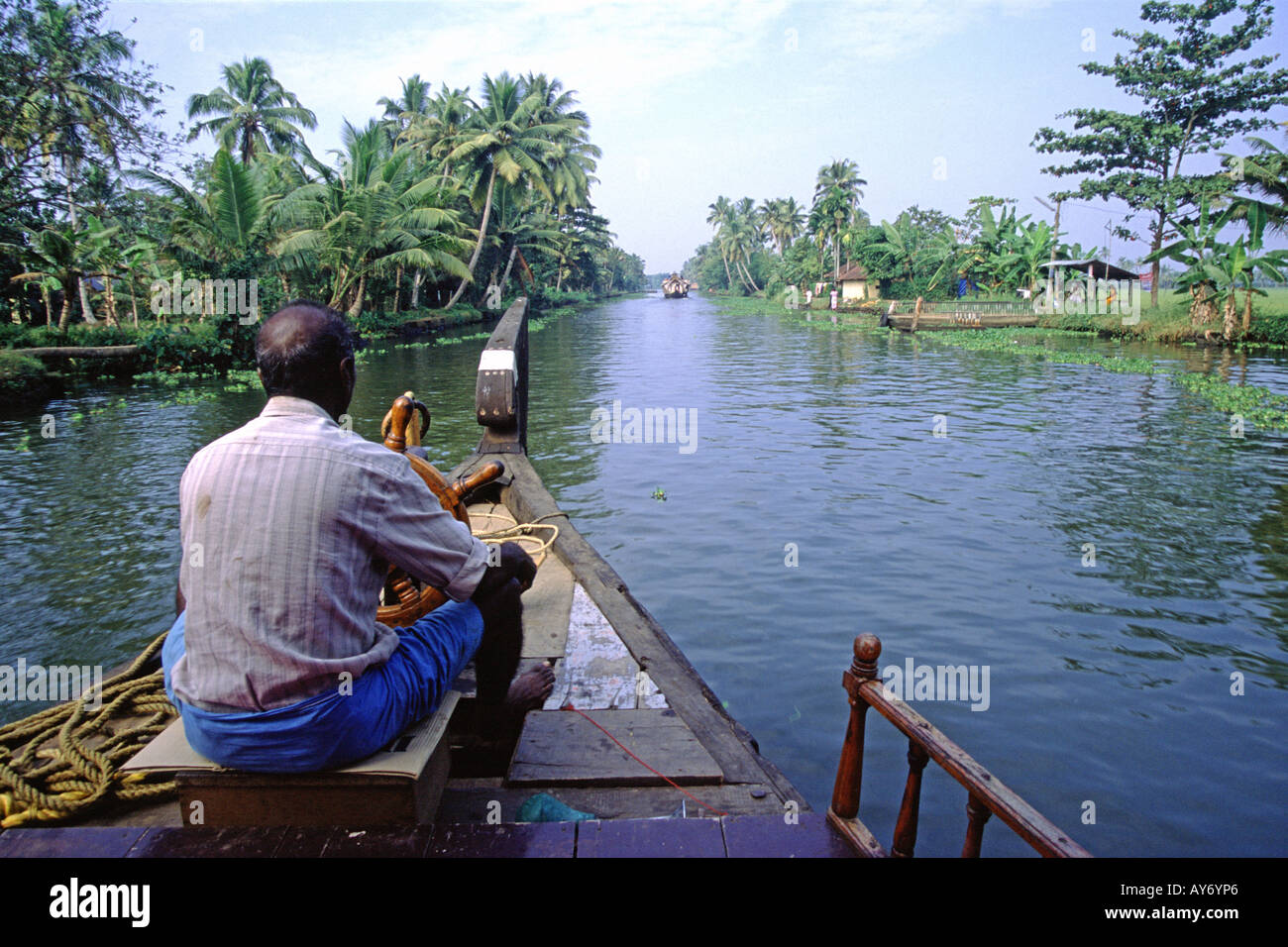 Boat driver on a houseboat on the backwaters of Kerala in India Stock ...