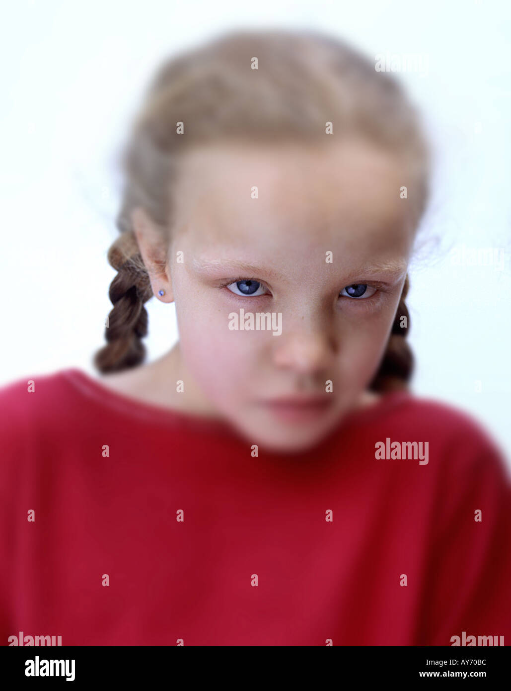Conceptual image showing young girl aged 10 staring at the camera ...