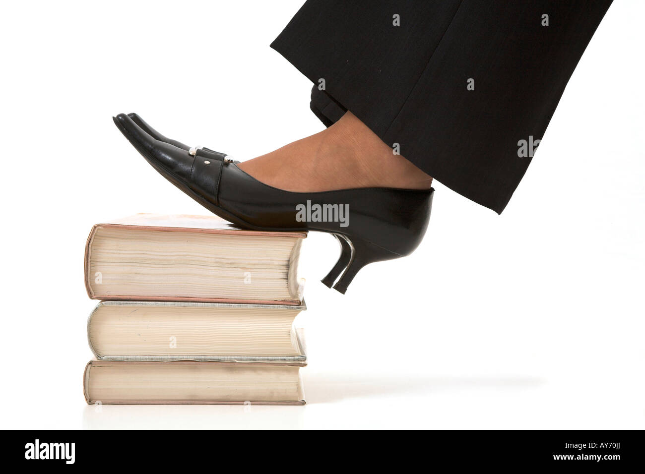 Woman standing on a pile of books Stock Photo - Alamy