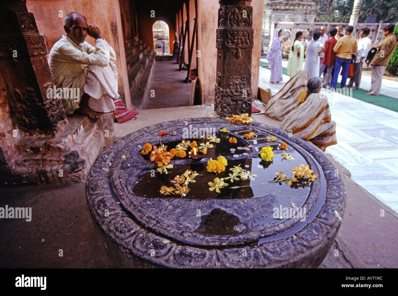 Buddha footprint covered with offerings at the Mahabodhi temple at ...