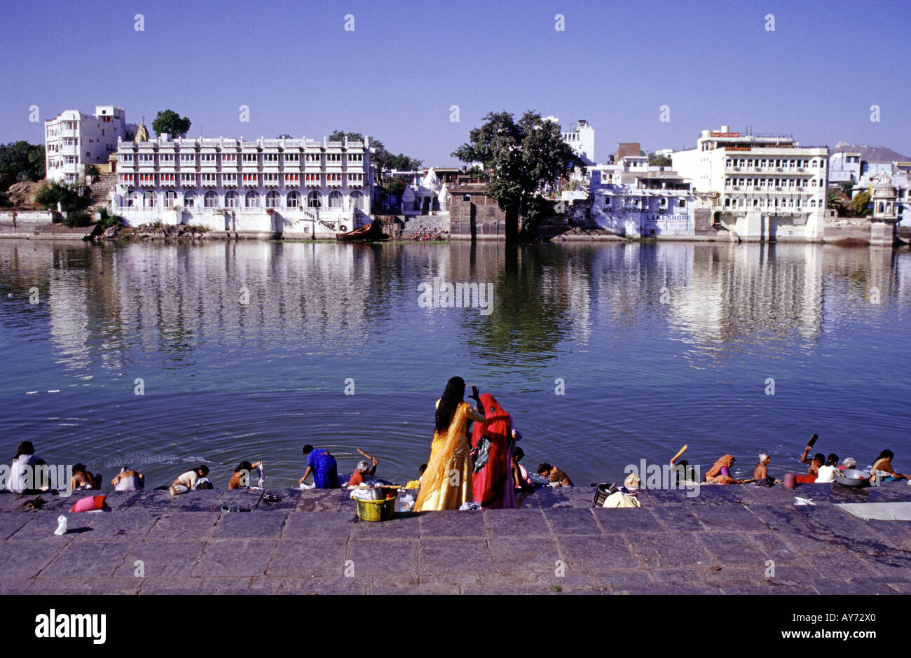 Women Washing Clothes In Lake Pichal In Udaipur Rajasthan India Stock