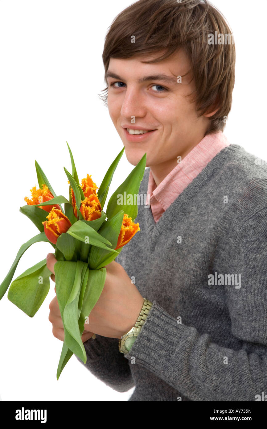 Young man offering flowers Stock Photo - Alamy