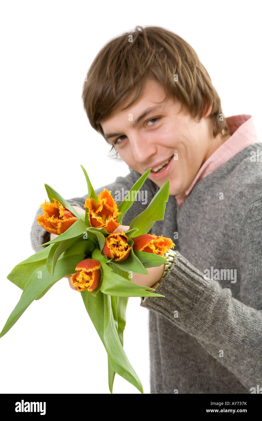 Young man offering flowers Stock Photo - Alamy