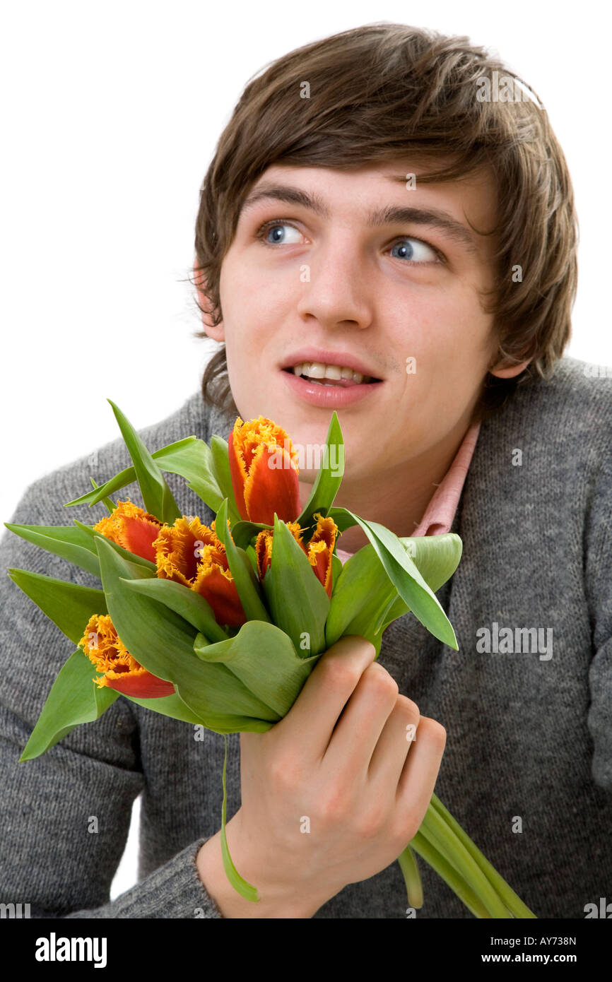 Young man offering flowers Stock Photo - Alamy