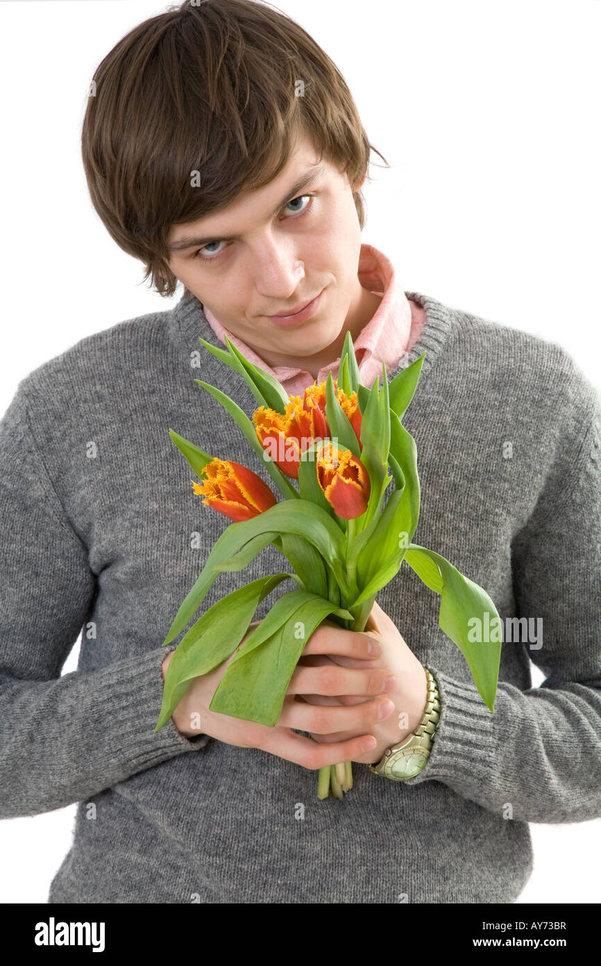 Young man offering flowers Stock Photo - Alamy