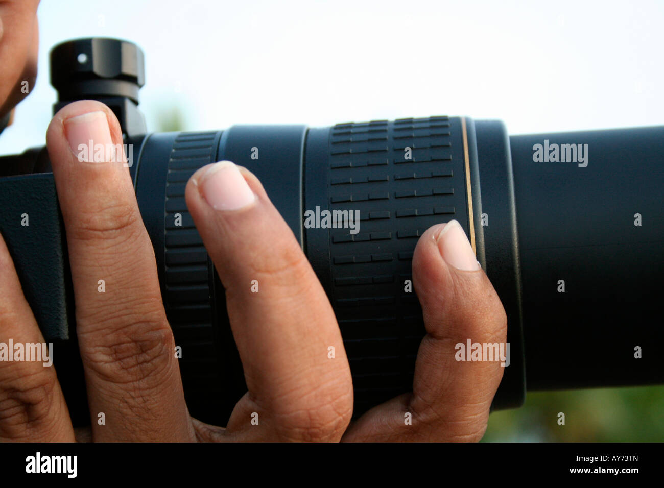 Detail of photographer handling an advanced professional camera with ...