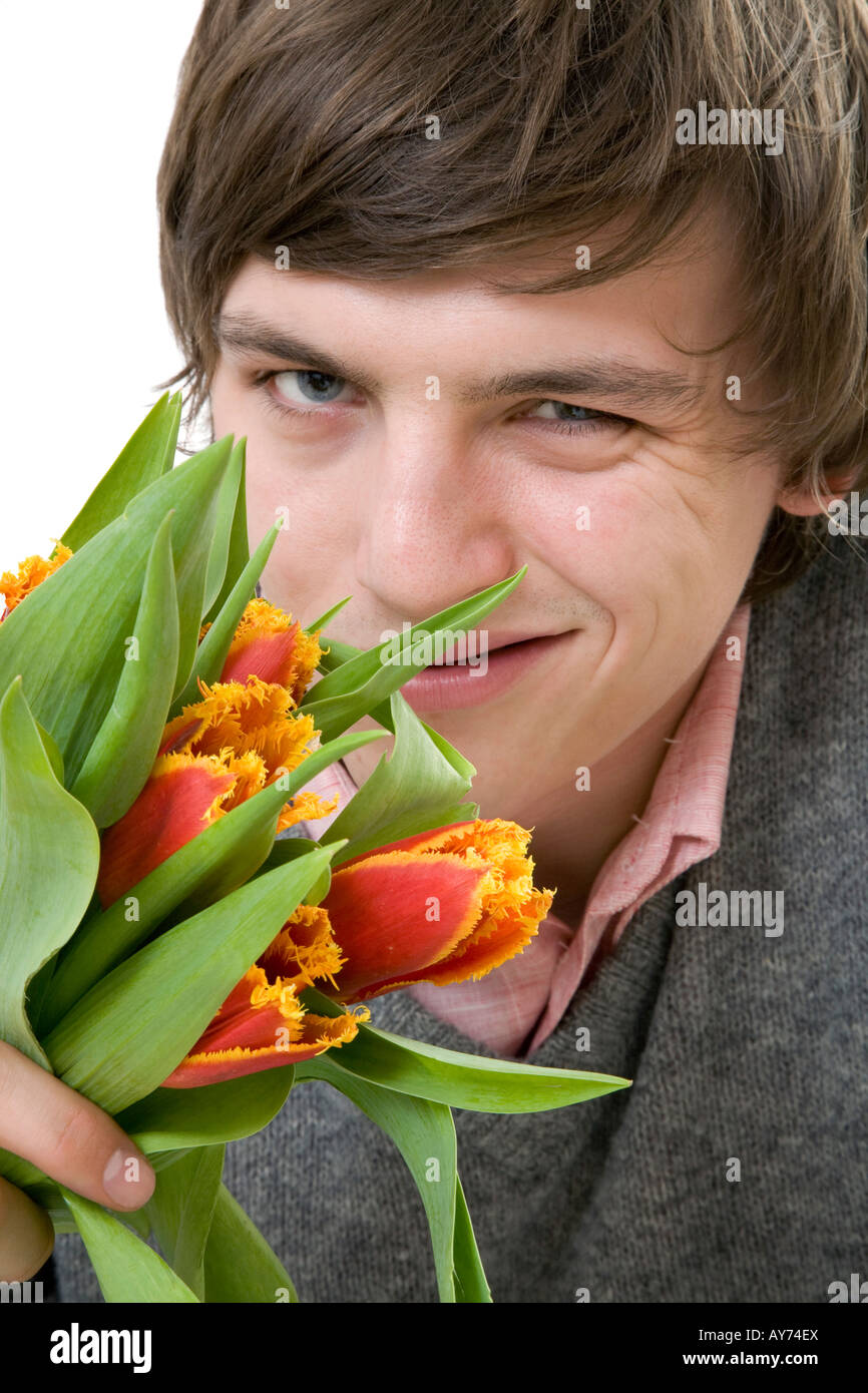 Young man offering flowers Stock Photo - Alamy