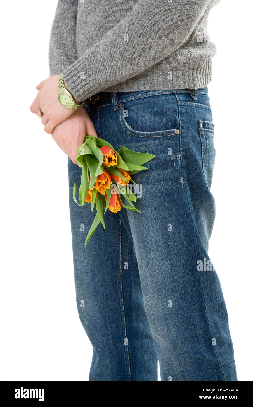 Young man offering flowers Stock Photo - Alamy
